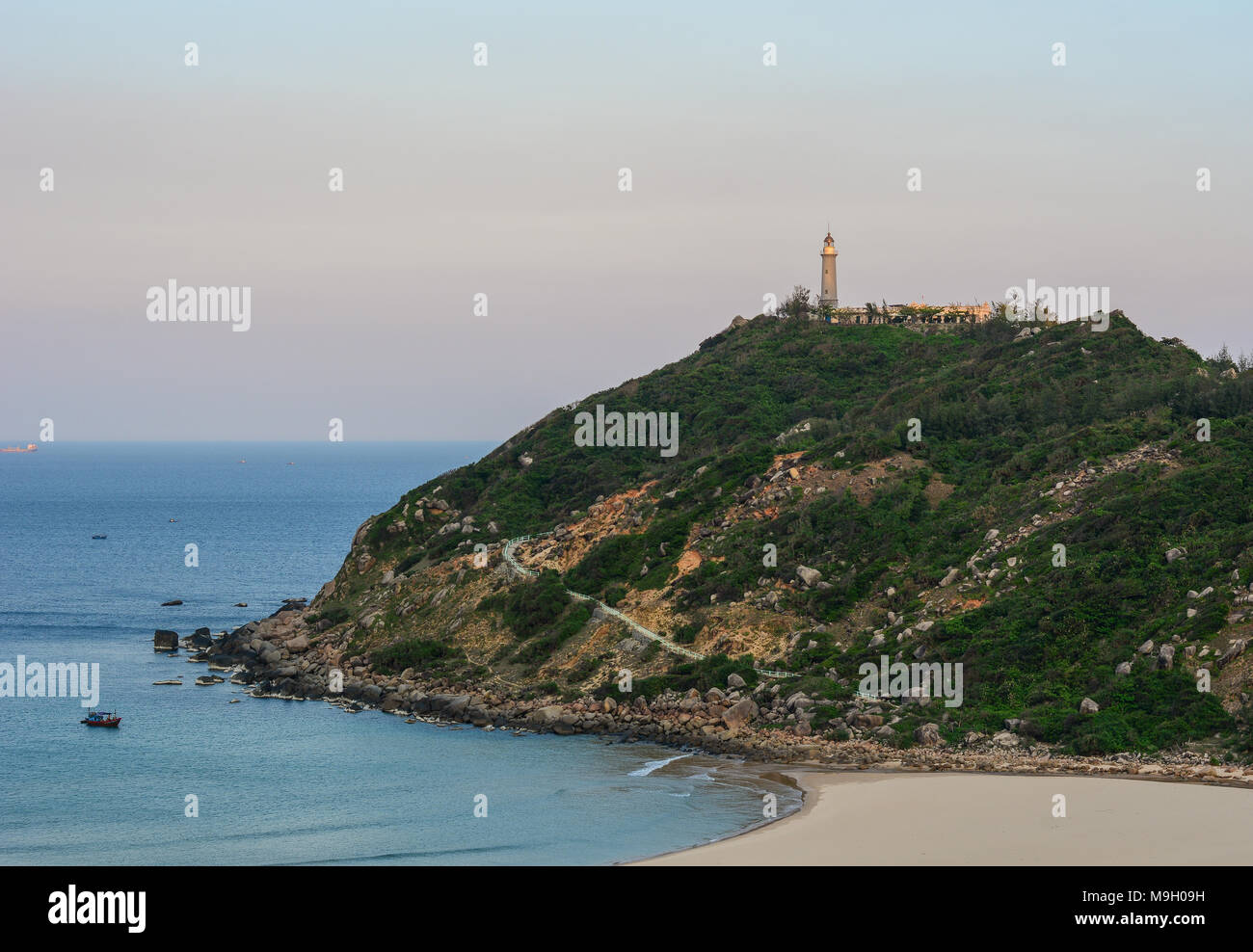 A lighthouse on top of mountain with the seascape in sunrise Stock ...