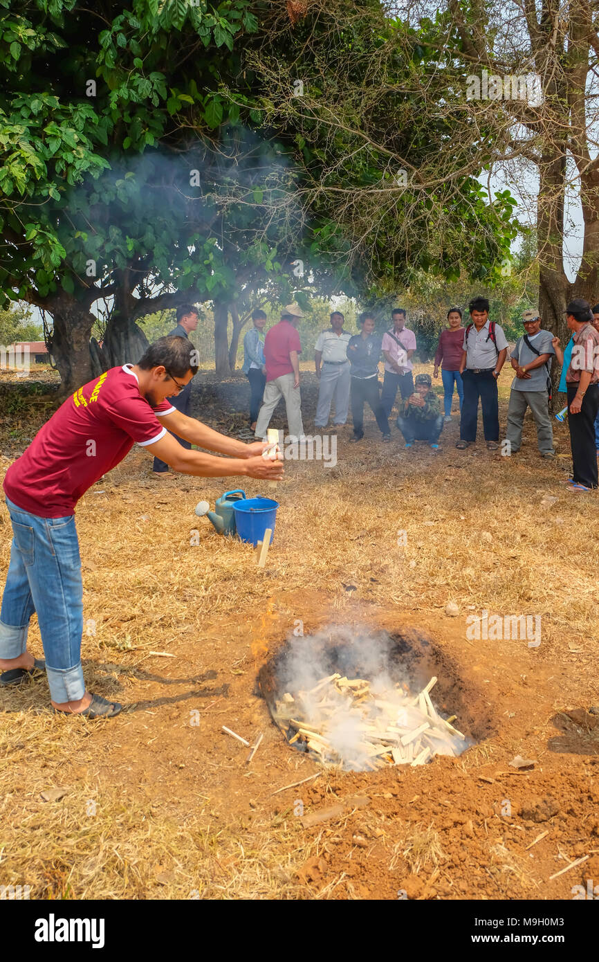 Tachileik, Myanmar - March 31 2017. Adding wood chippings to fire in ...