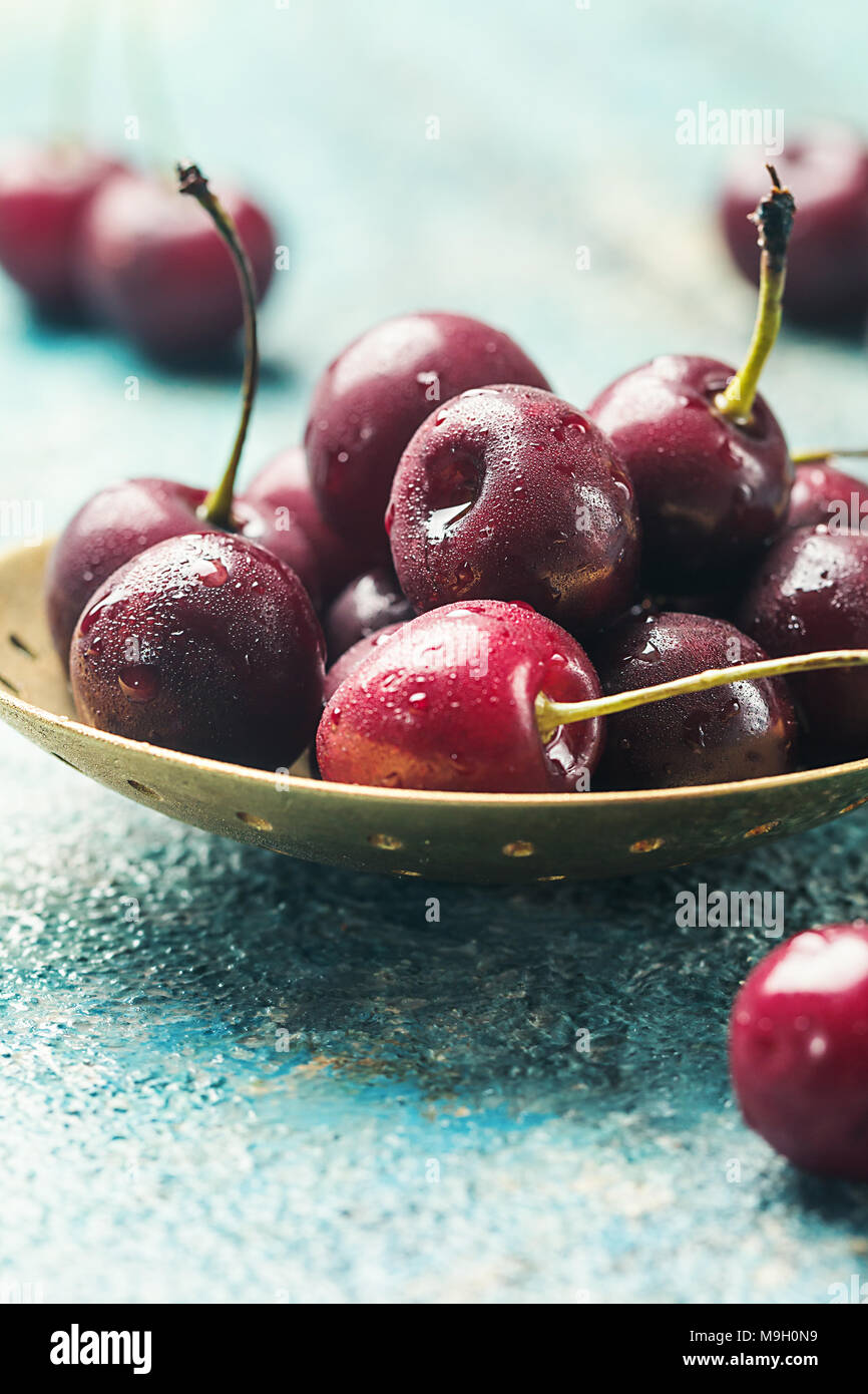 Fresh cherry in spoon over blue background. ripe cherries. sweet berries Stock Photo - Alamy