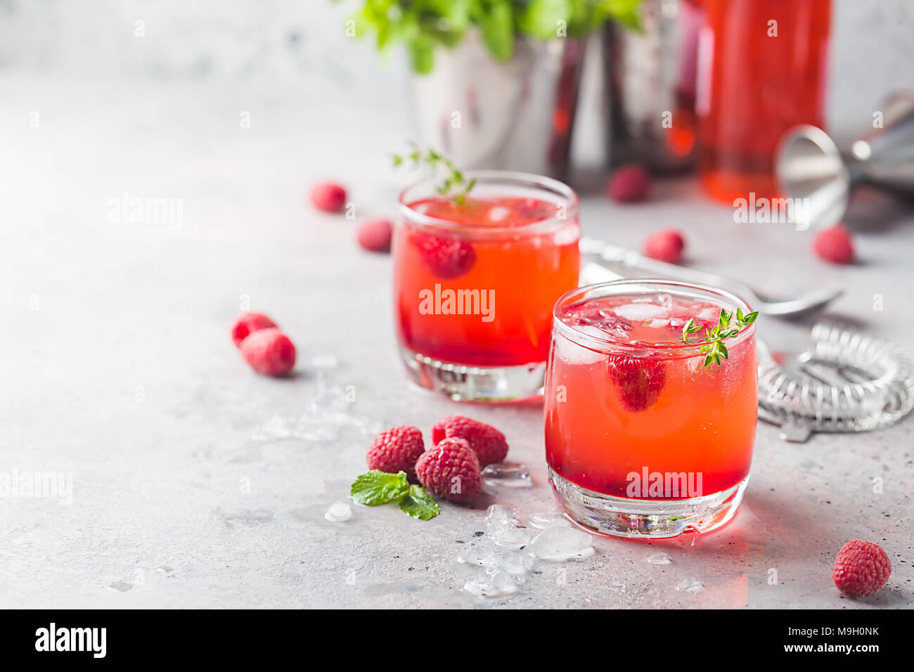 Red refreshing cold raspberry lemonade in a glasses with ice and ...