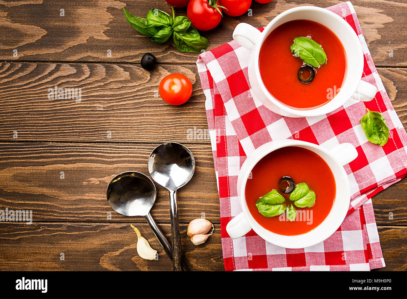 Tomato soup in a white bowl on wooden table, top view Stock Photo - Alamy