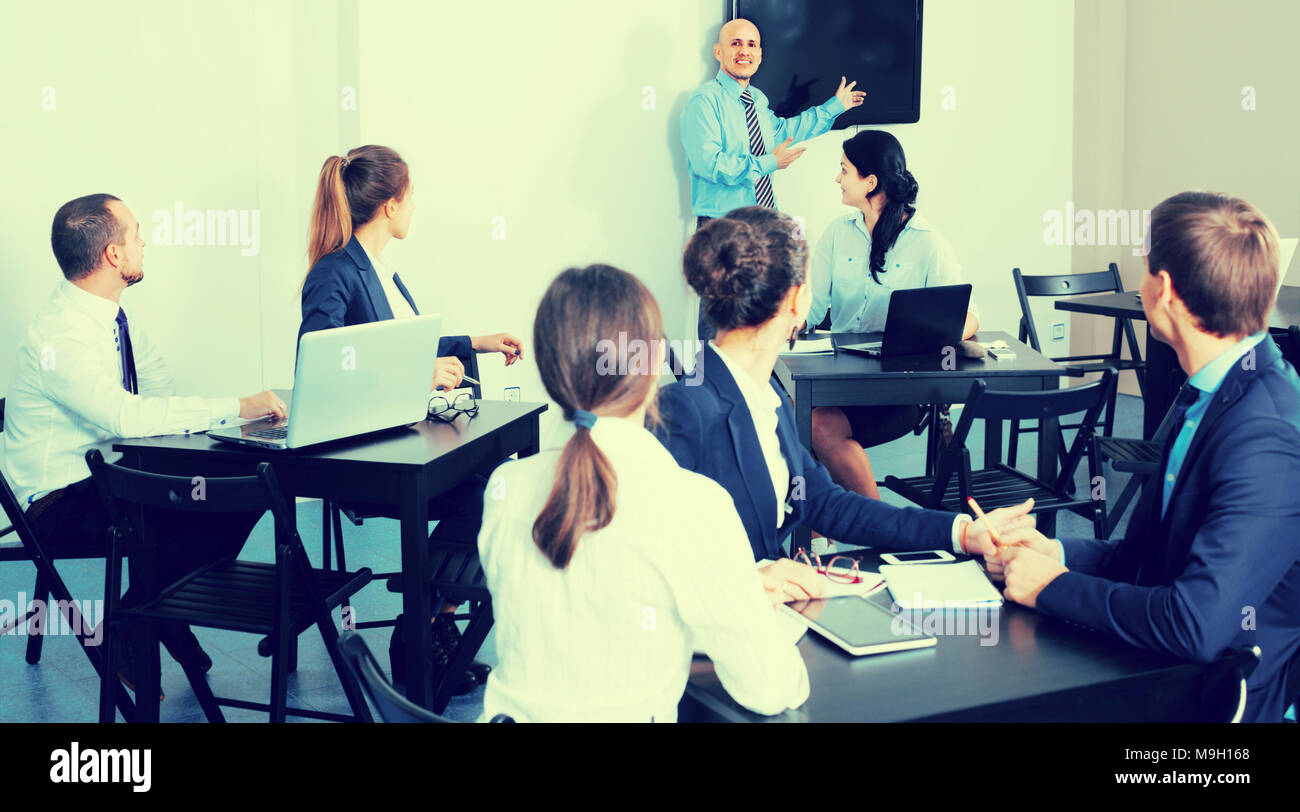 Employee presenting his idea on project to team in office Stock Photo ...