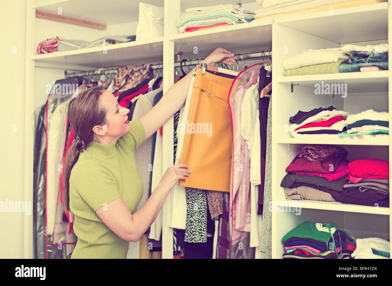 Woman arranging closet hi-res stock photography and images - Alamy