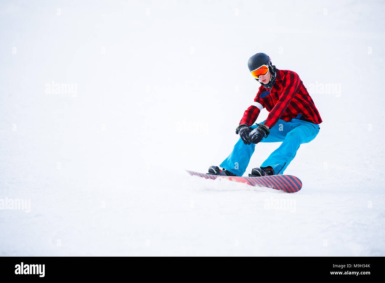 Image of athlete with snowboard riding in snowy resort Stock Photo - Alamy