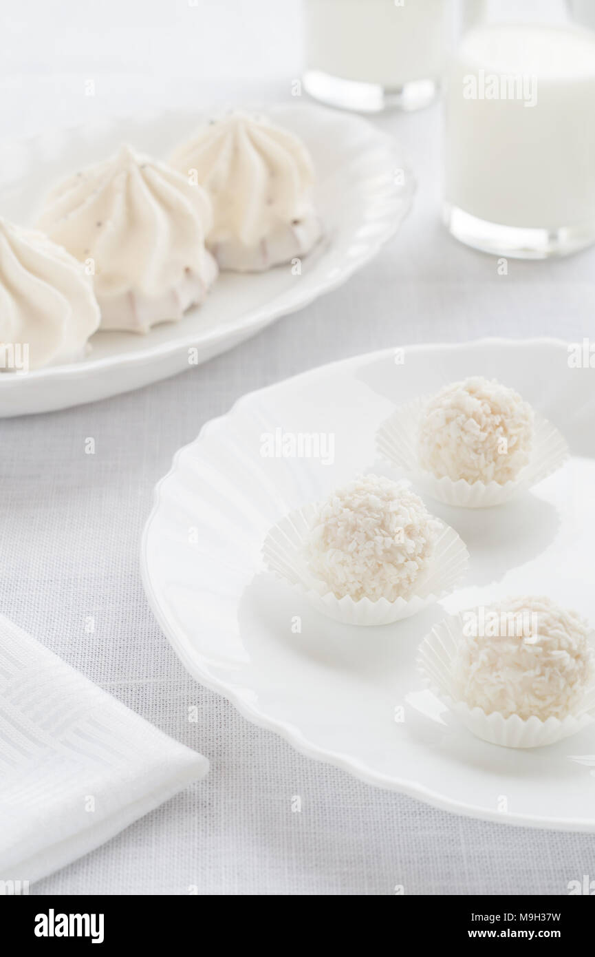 White candy and cake on a light background Stock Photo - Alamy