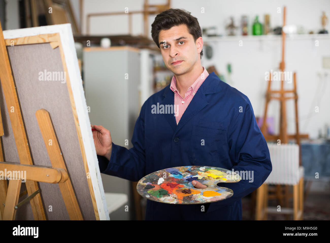 Male artist concentrating on painting hi-res stock photography and ...