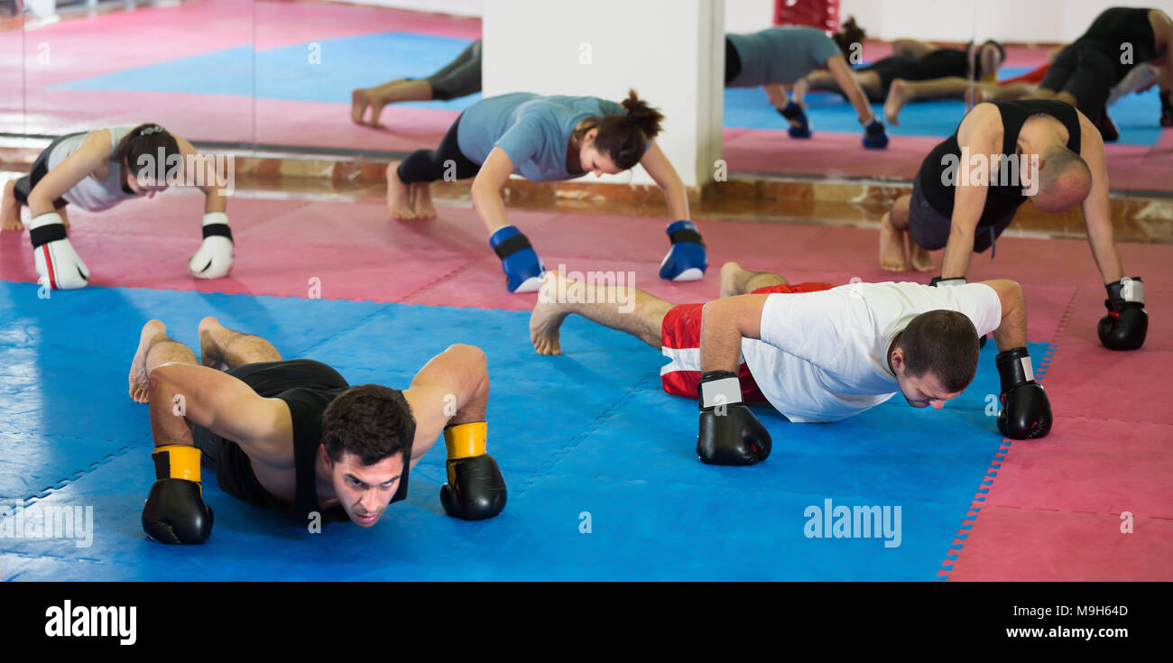 Positive people practicing boxing punches in the boxing hall Stock ...