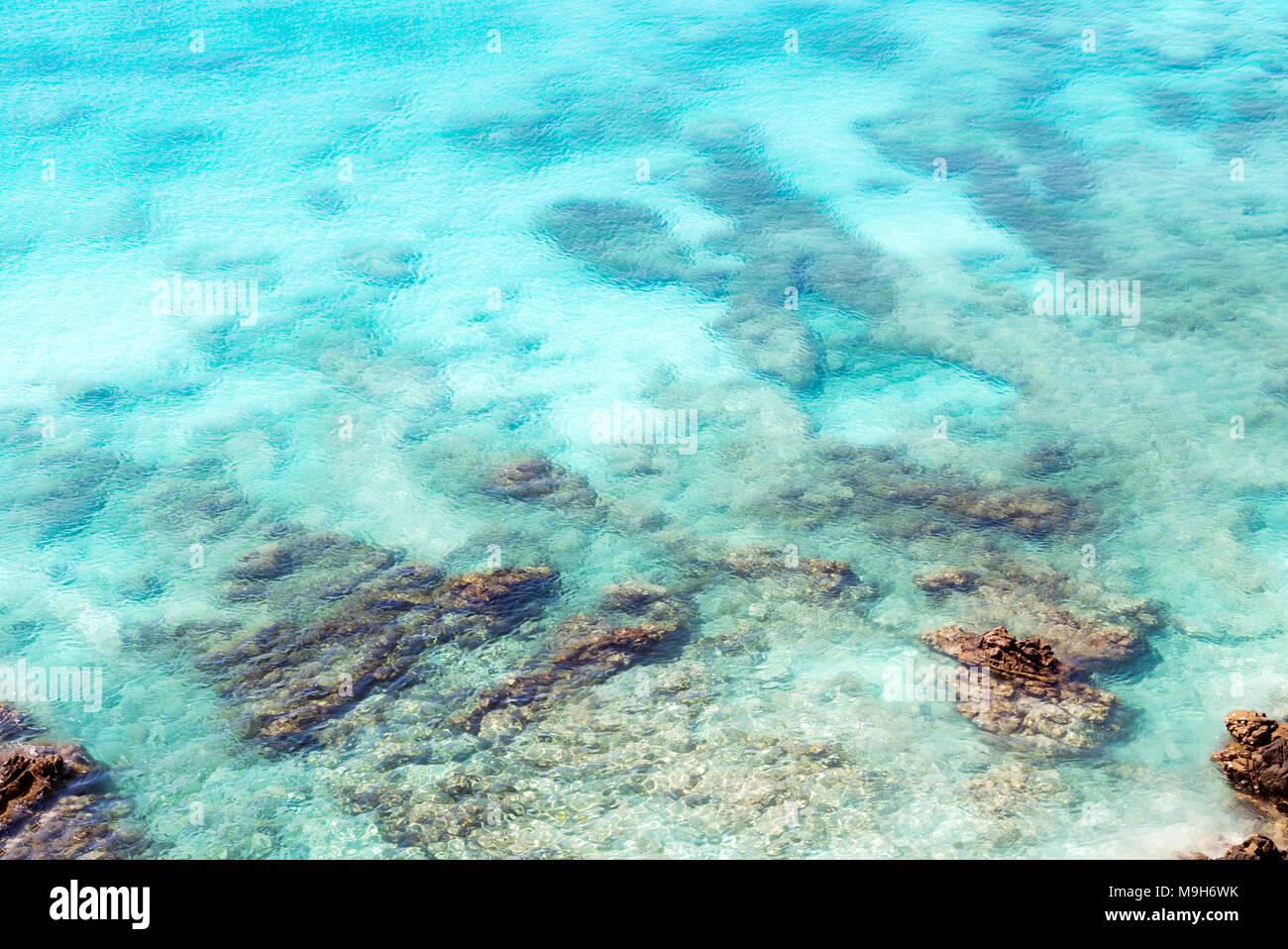 Top view of transparent shallow turquoise ocean sea water surface and ...