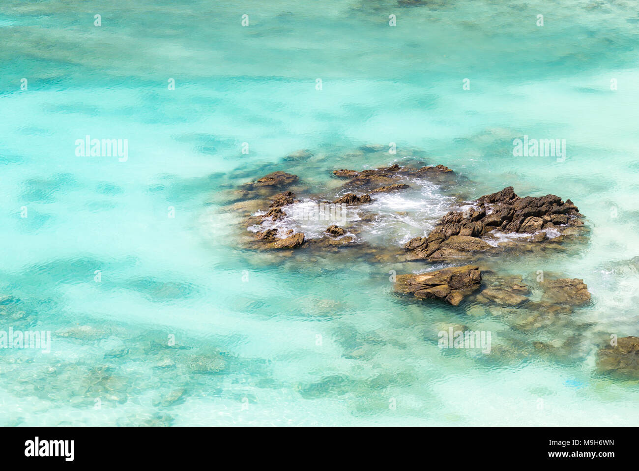 Top view of transparent shallow turquoise ocean sea water surface and ...