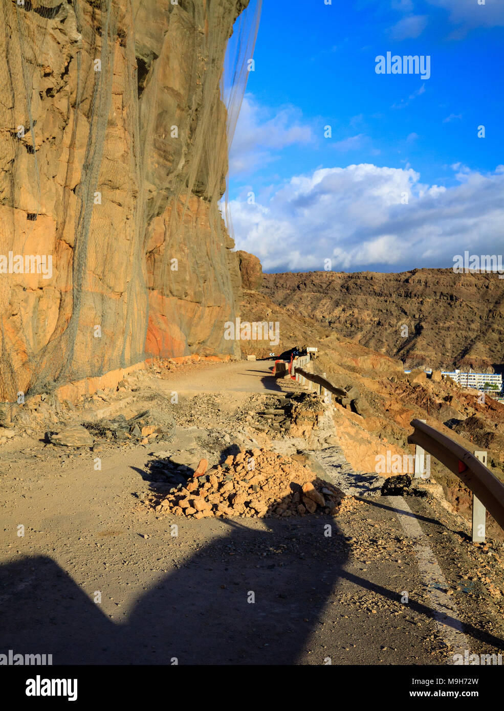 Falling rocks and big collapse hole on closed mountain road Stock Photo ...