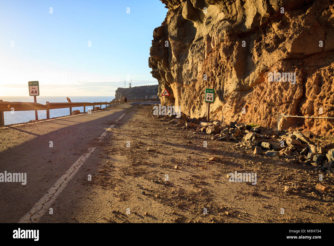 Falling rocks and big collapse hole on closed mountain road Stock Photo ...