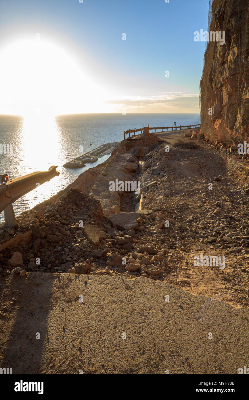 Falling rocks and big collapse hole on closed mountain road under the ...