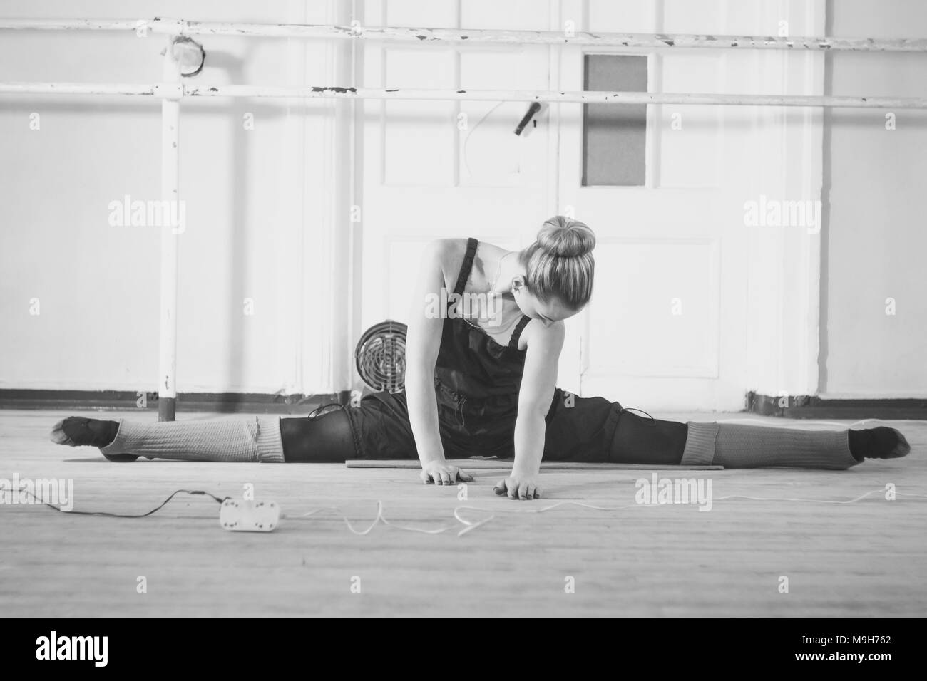 the dancer makes the warm-up in the ballet hall Stock Photo - Alamy