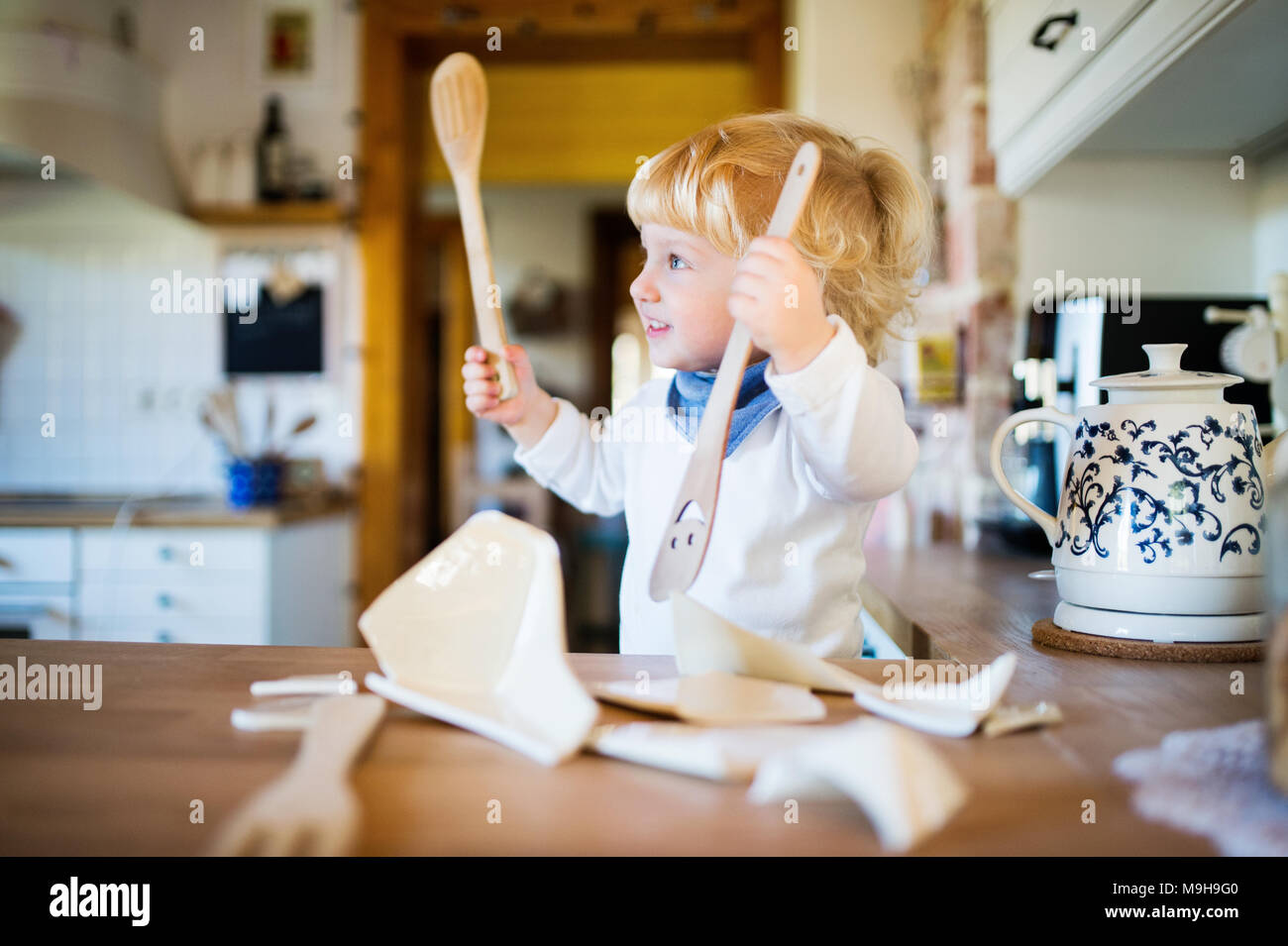 Toddler boy in a dangerous situation at home. Domestic accident. Child ...