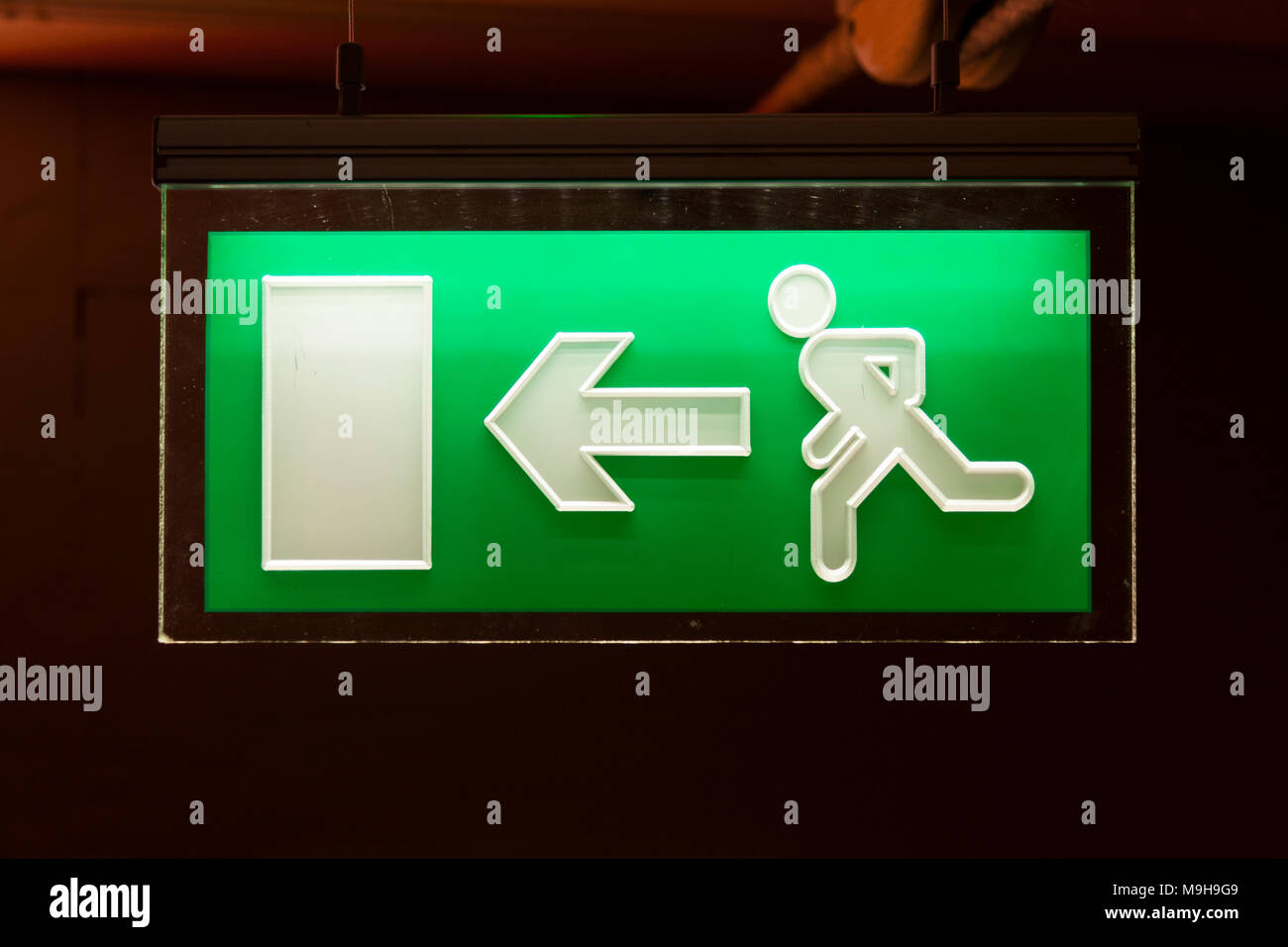 Emergency exit / fire escape sign of an illuminated type, for use in ...