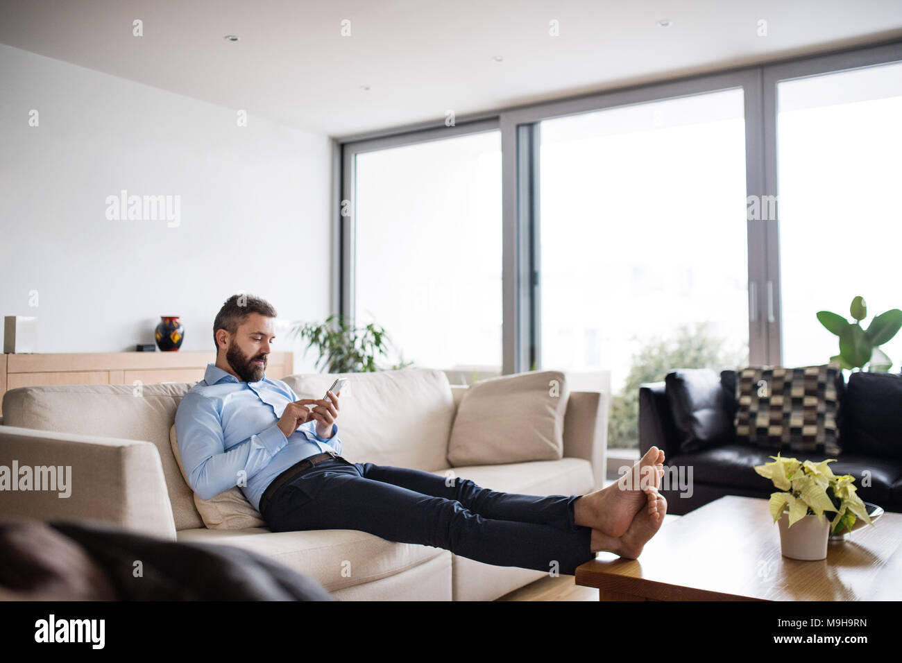 Man barefoot feet table hi-res stock photography and images - Alamy