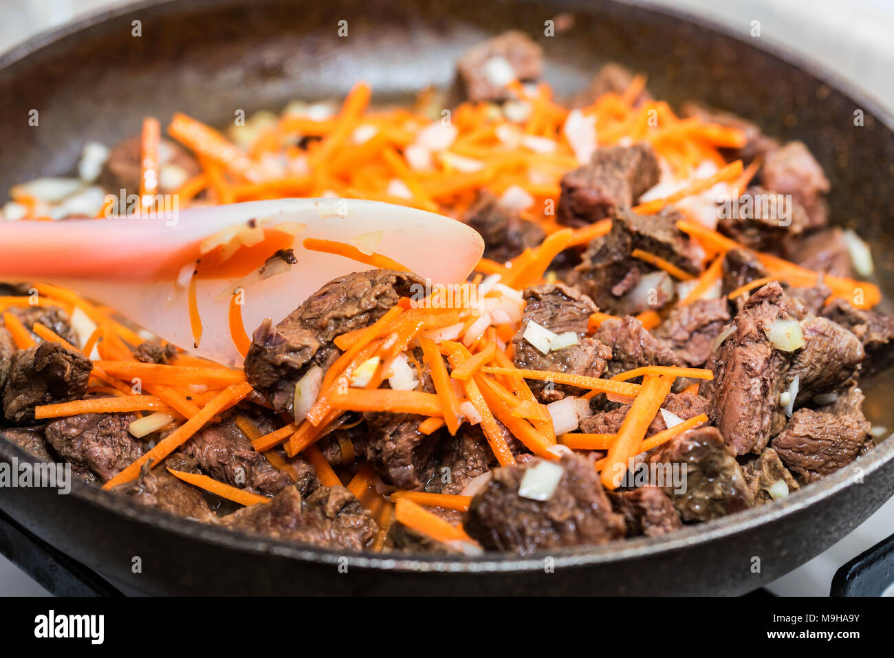 Beef stew with vegetables in frying pan Stock Photo - Alamy