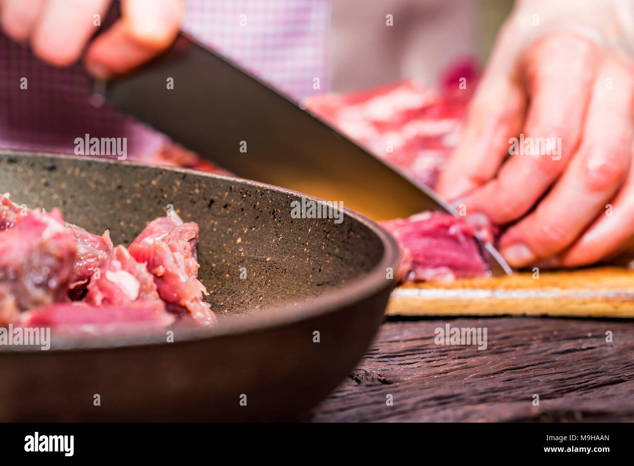 Female hands cut raw beef close Stock Photo - Alamy