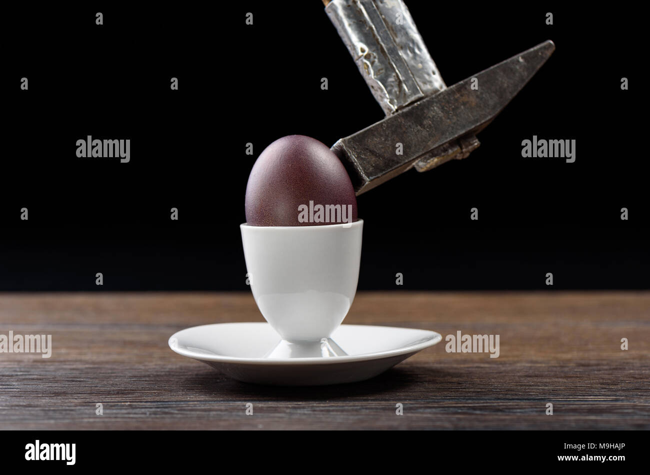 Easter egg open with a hammer Stock Photo - Alamy