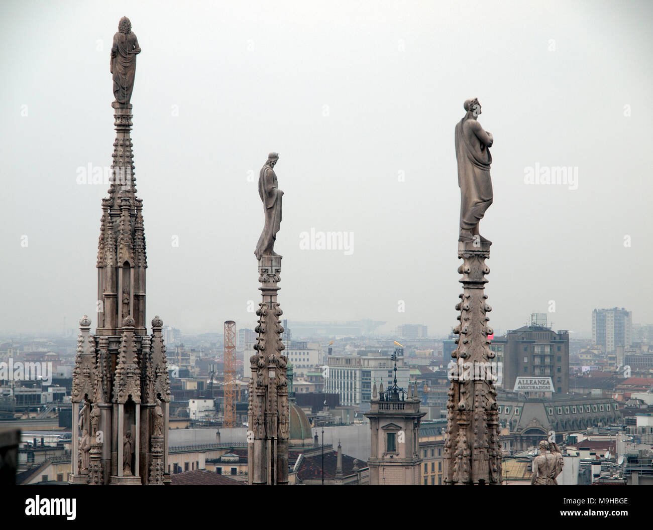 Statues of religious figures high up on the roof of Milan Cathedral ...
