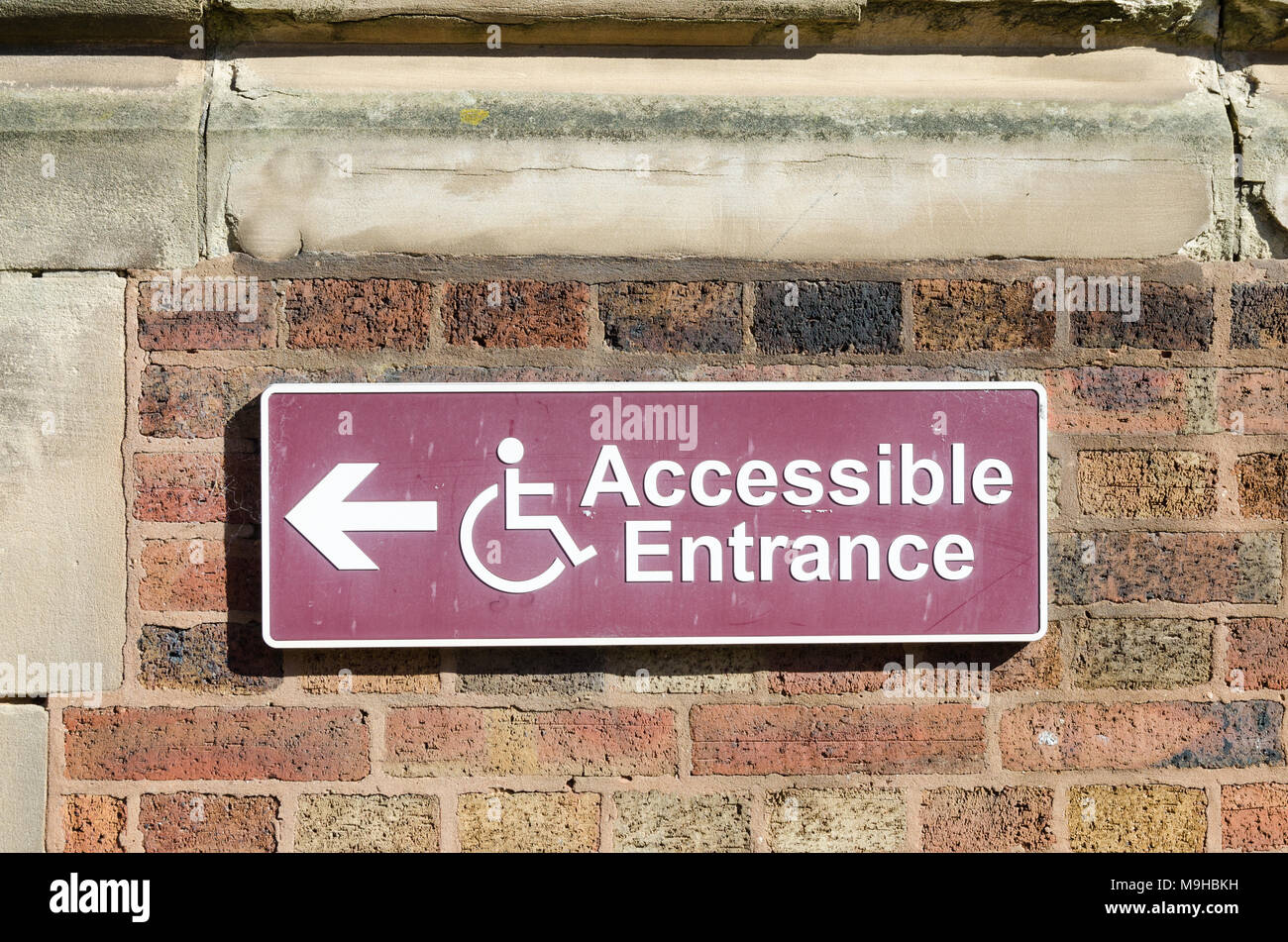 Sign on brick wall showing wheelchair accessible entrance Stock Photo ...