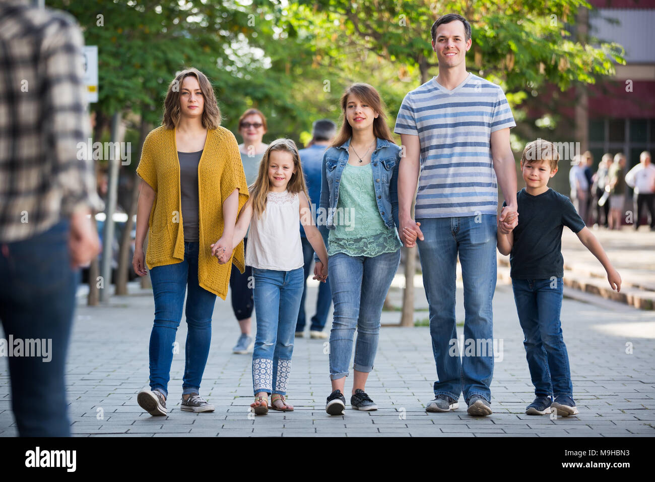 Happy family on a walk in the park in spring Stock Photo - Alamy