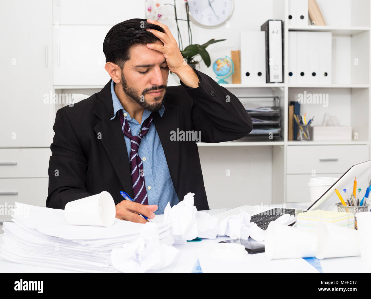 Spanish male worker is having complicated issue with project in office ...