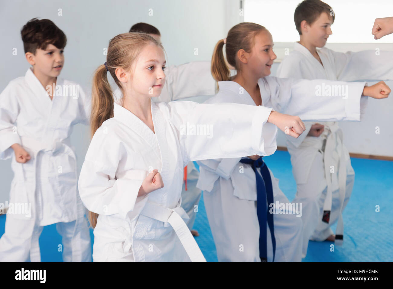 Children training a new moves with coach during karate class Stock ...