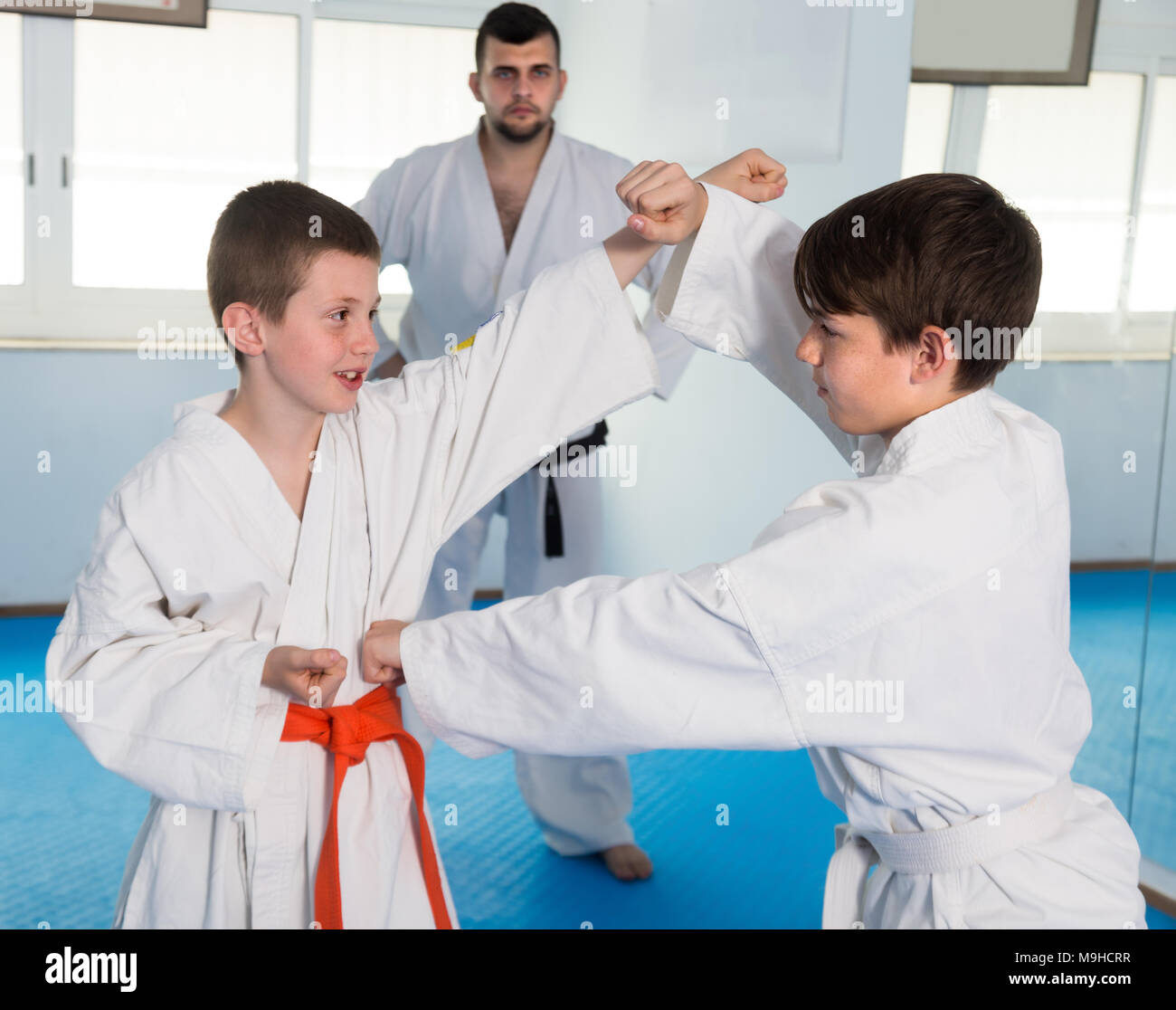 Young boys training in pair to use karate technique during class Stock ...