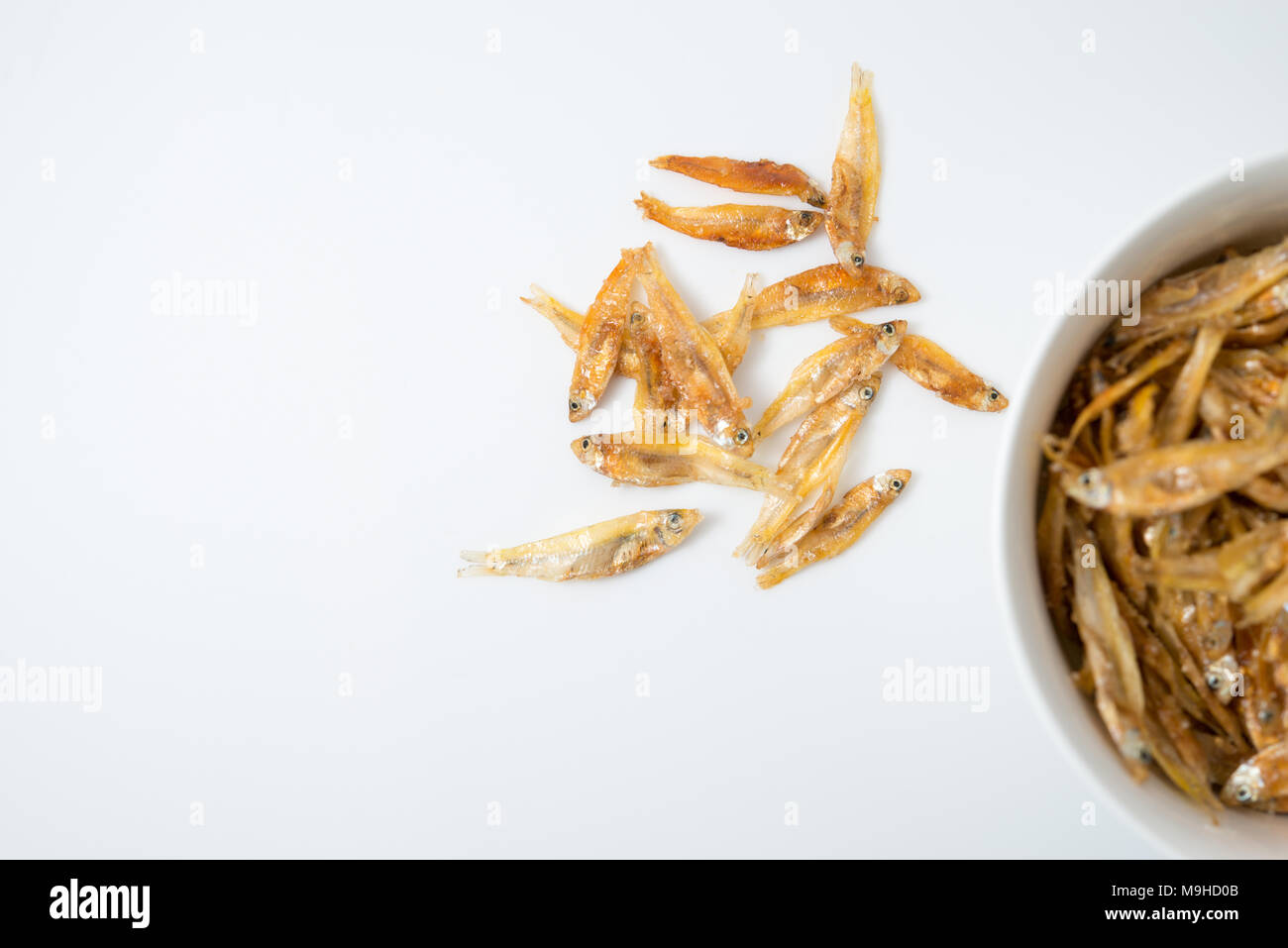 fried small fish in a cup on white background Stock Photo - Alamy