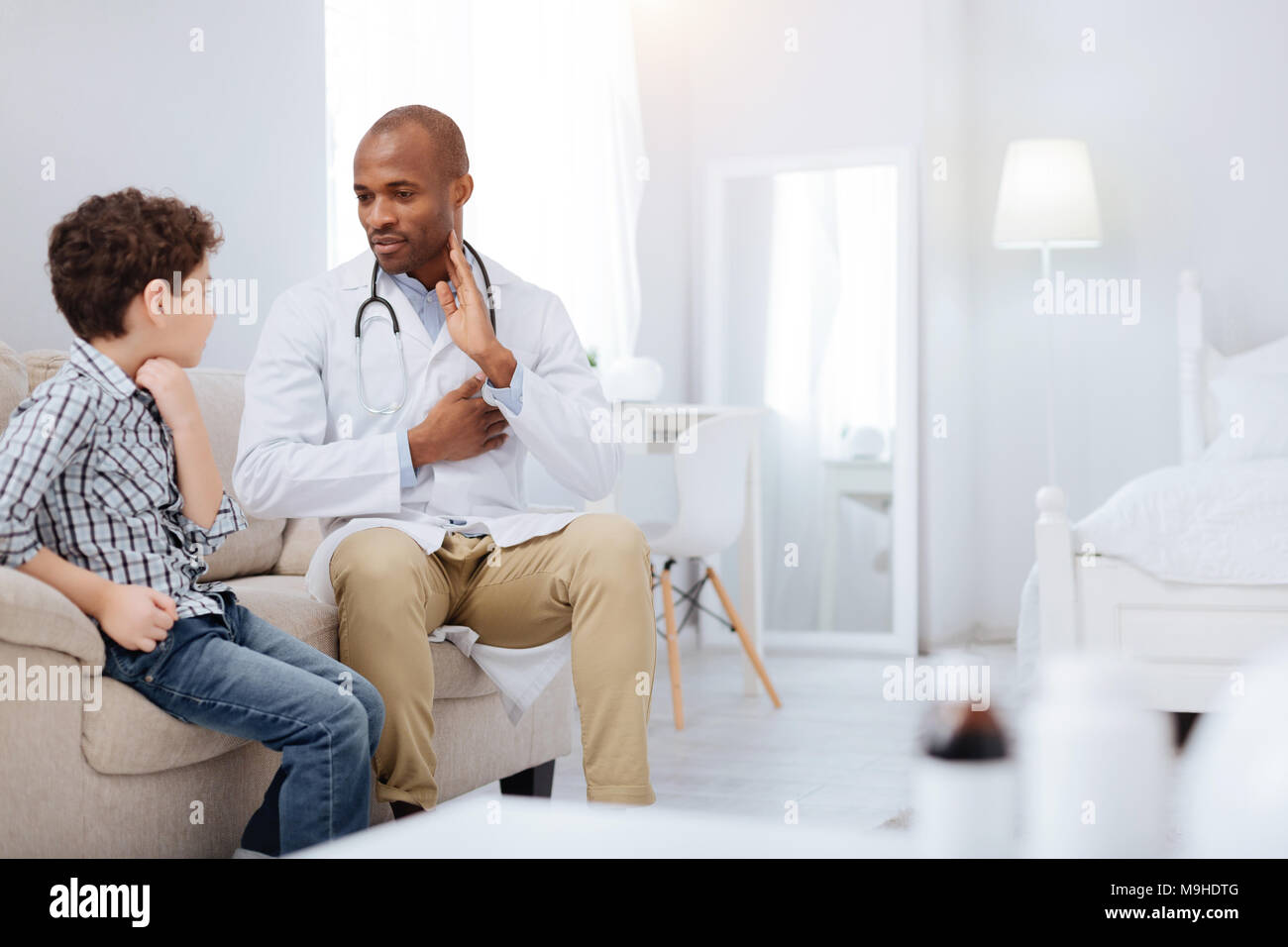 Successful male doctor sharing knowledge with boy Stock Photo - Alamy