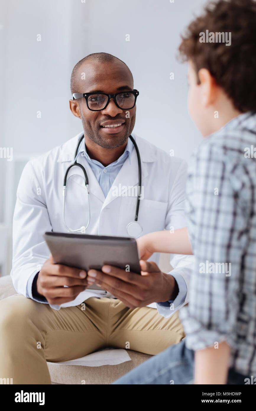 Professional male doctor teaching boy Stock Photo - Alamy