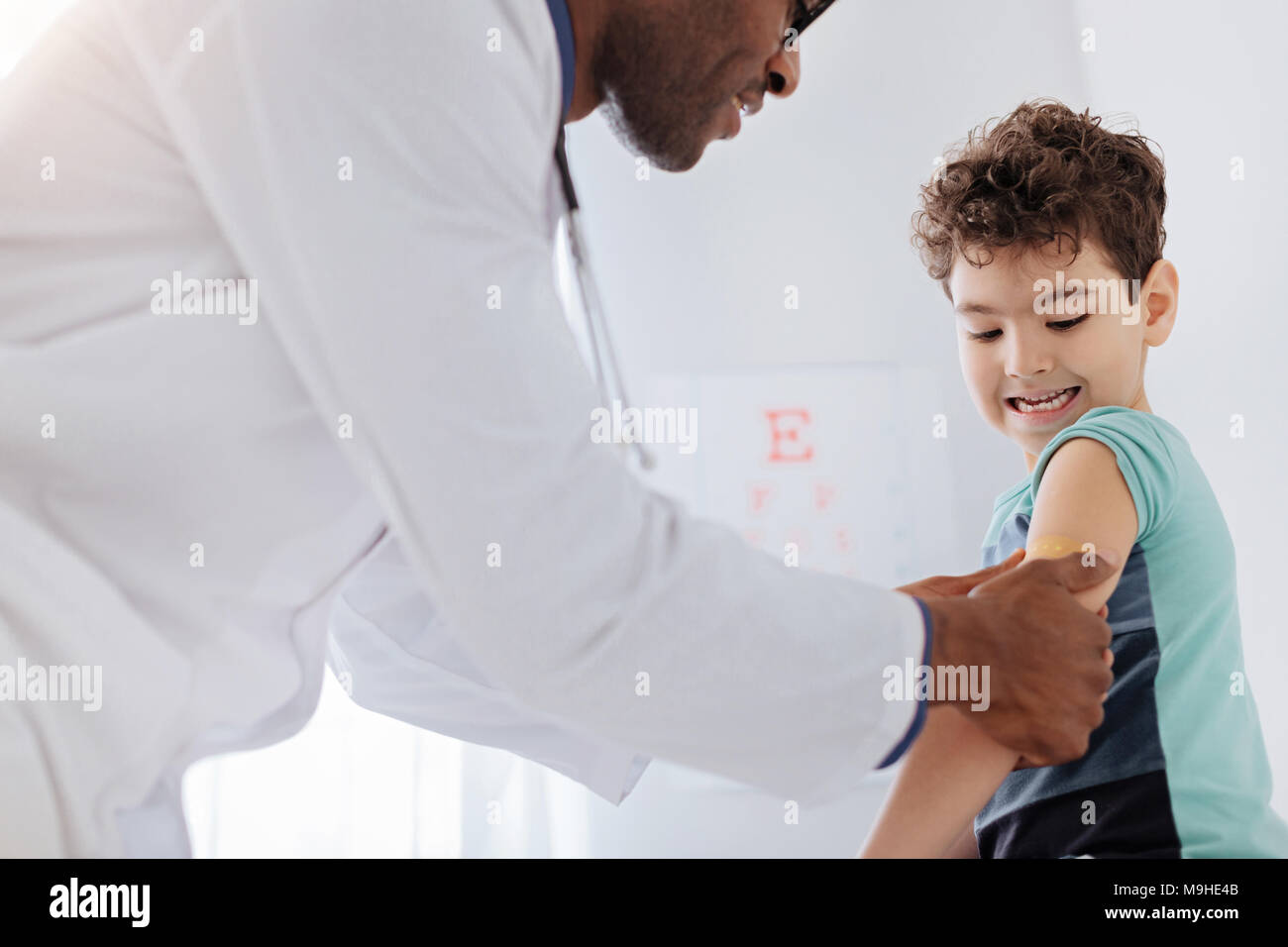 Skillful male doctor putting patch Stock Photo - Alamy