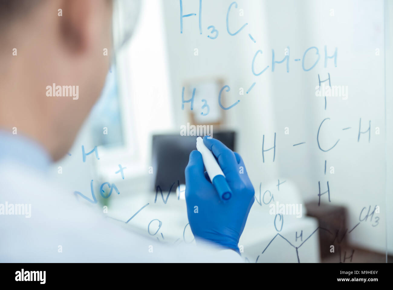 Inspired smart scientist writing a formula Stock Photo - Alamy