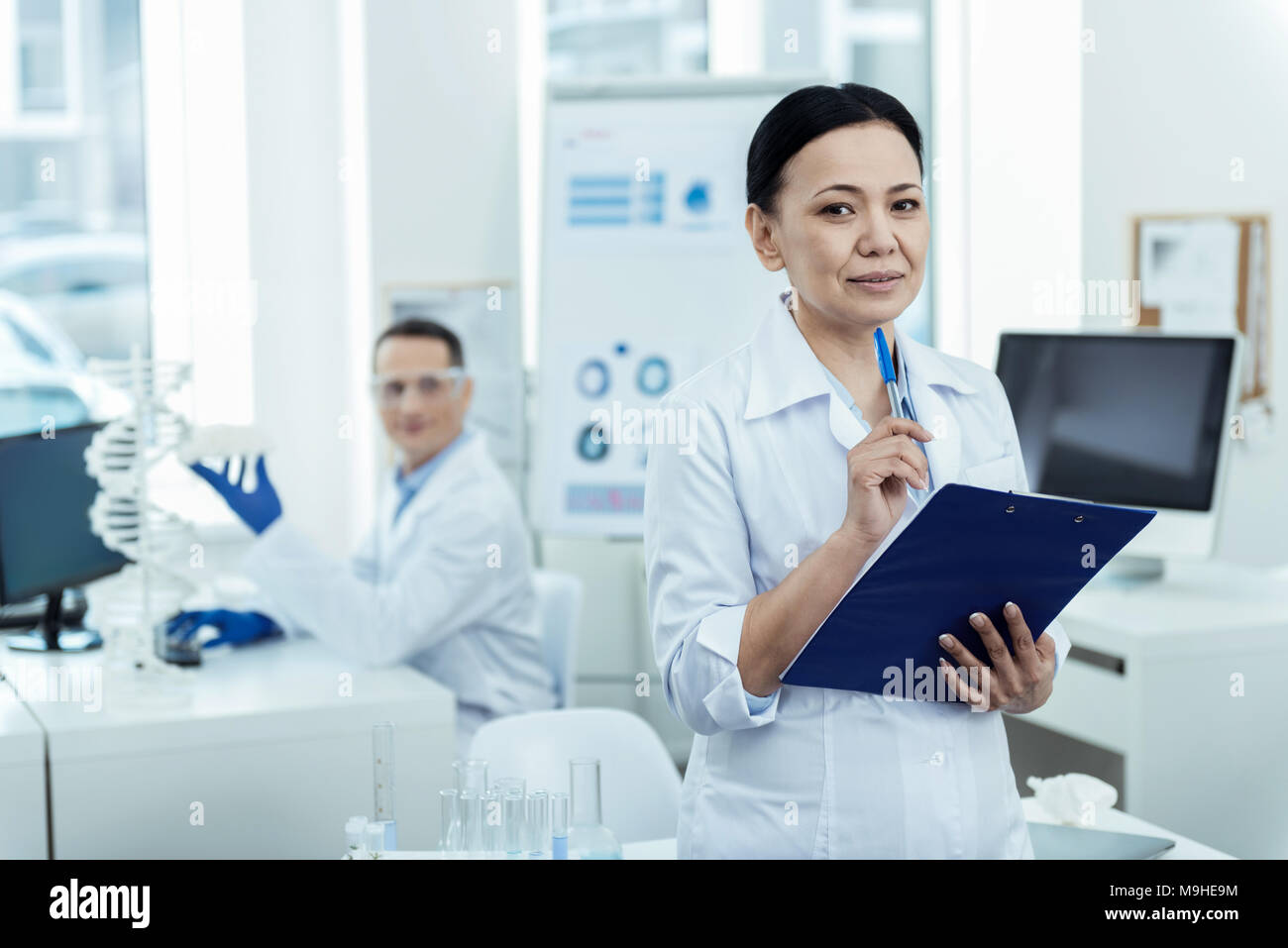 Inspired smart scientist working in the lab with her colleague Stock ...