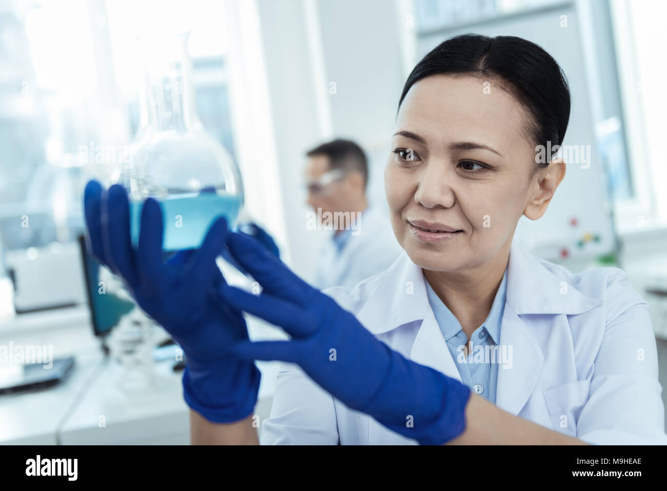 Smiling researcher making a test in the lab Stock Photo - Alamy