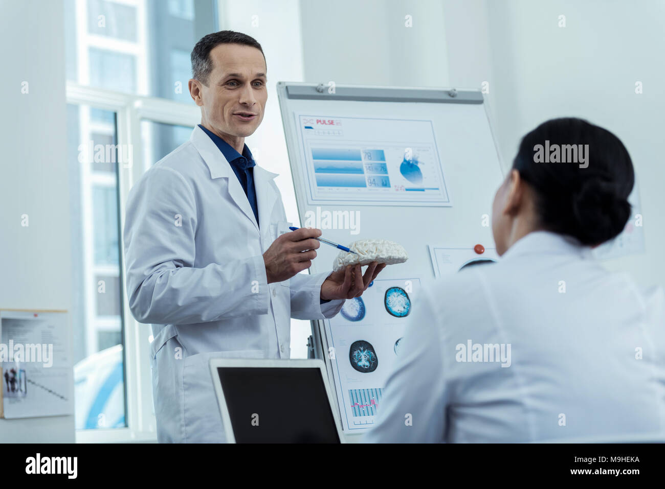 Professional doctors discussing future brain surgery Stock Photo - Alamy