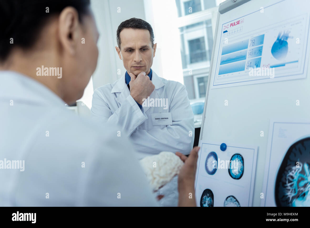 Professional doctors discusing future neurosurgery Stock Photo - Alamy