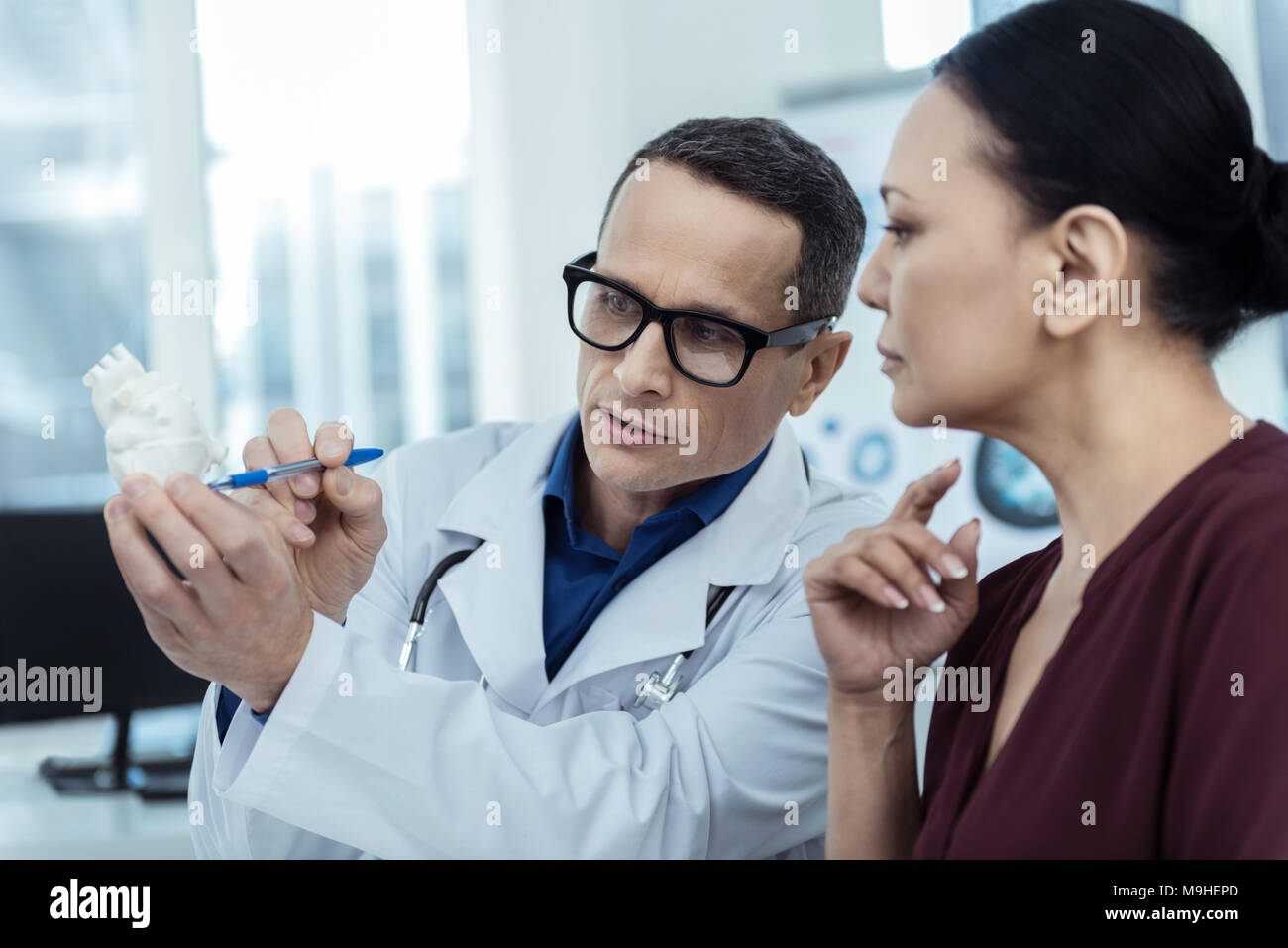 Professional cardiologist talking with his patient Stock Photo - Alamy