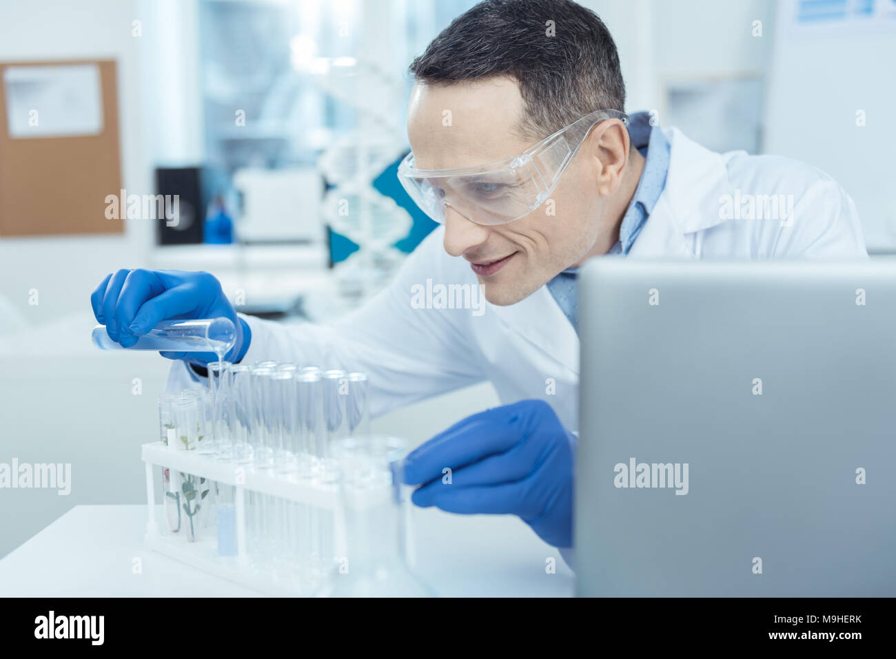 Positive scientist making an experiment in a lab Stock Photo - Alamy