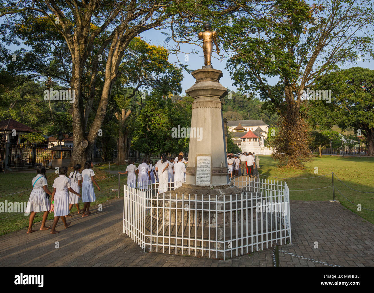 School students walking near statue of Madduma Bandara at Temple of the ...