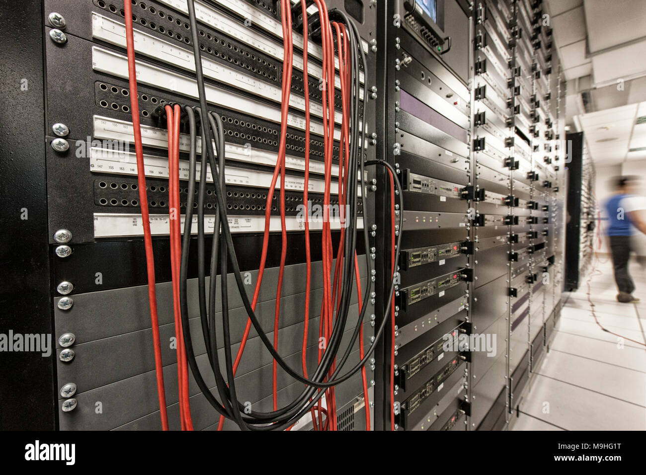 Computer server room racks with technician in background Stock Photo ...