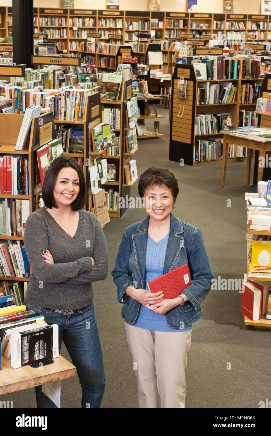 Portrait of caucasian female and Asian Americna female owners of a ...