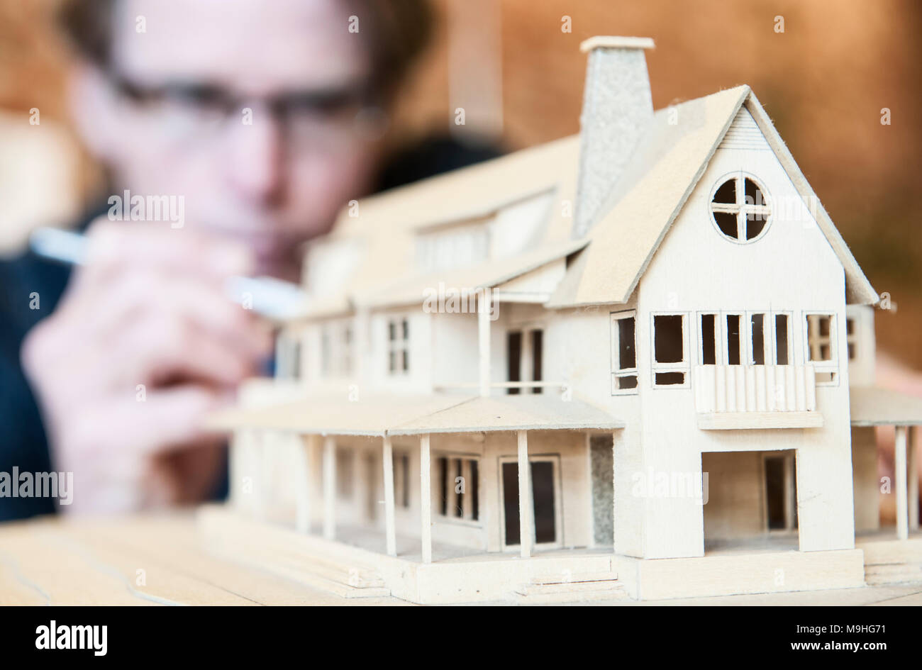 Caucasian male architect working on a scale model of a new home Stock ...