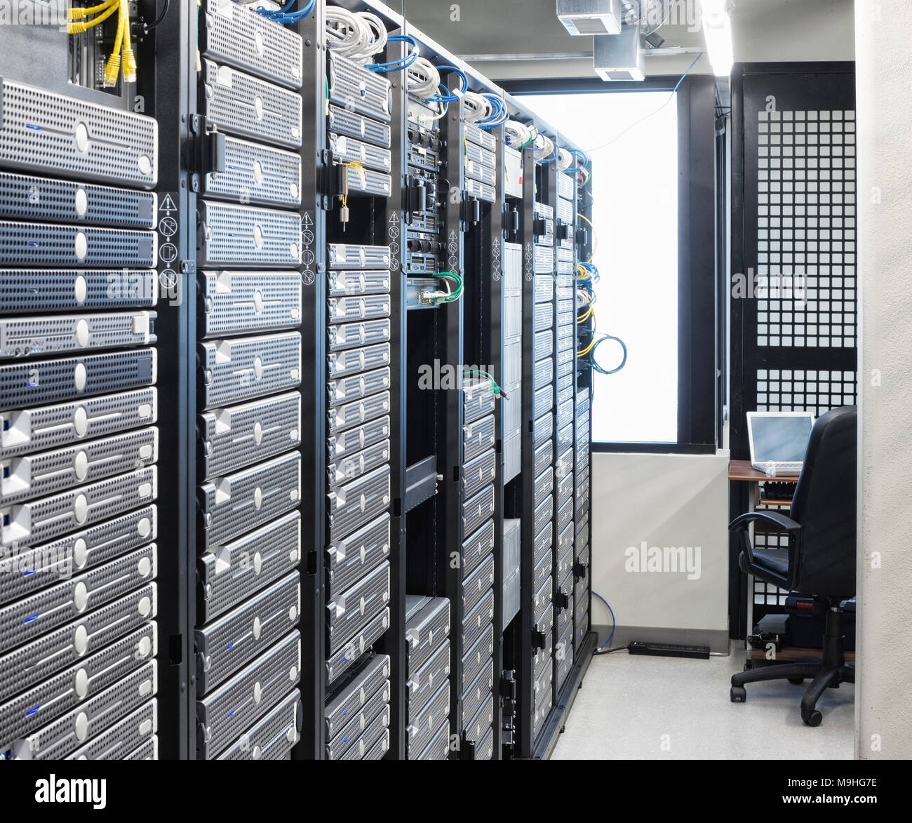 Servers in an aisle of racks in a computer server farm Stock Photo - Alamy