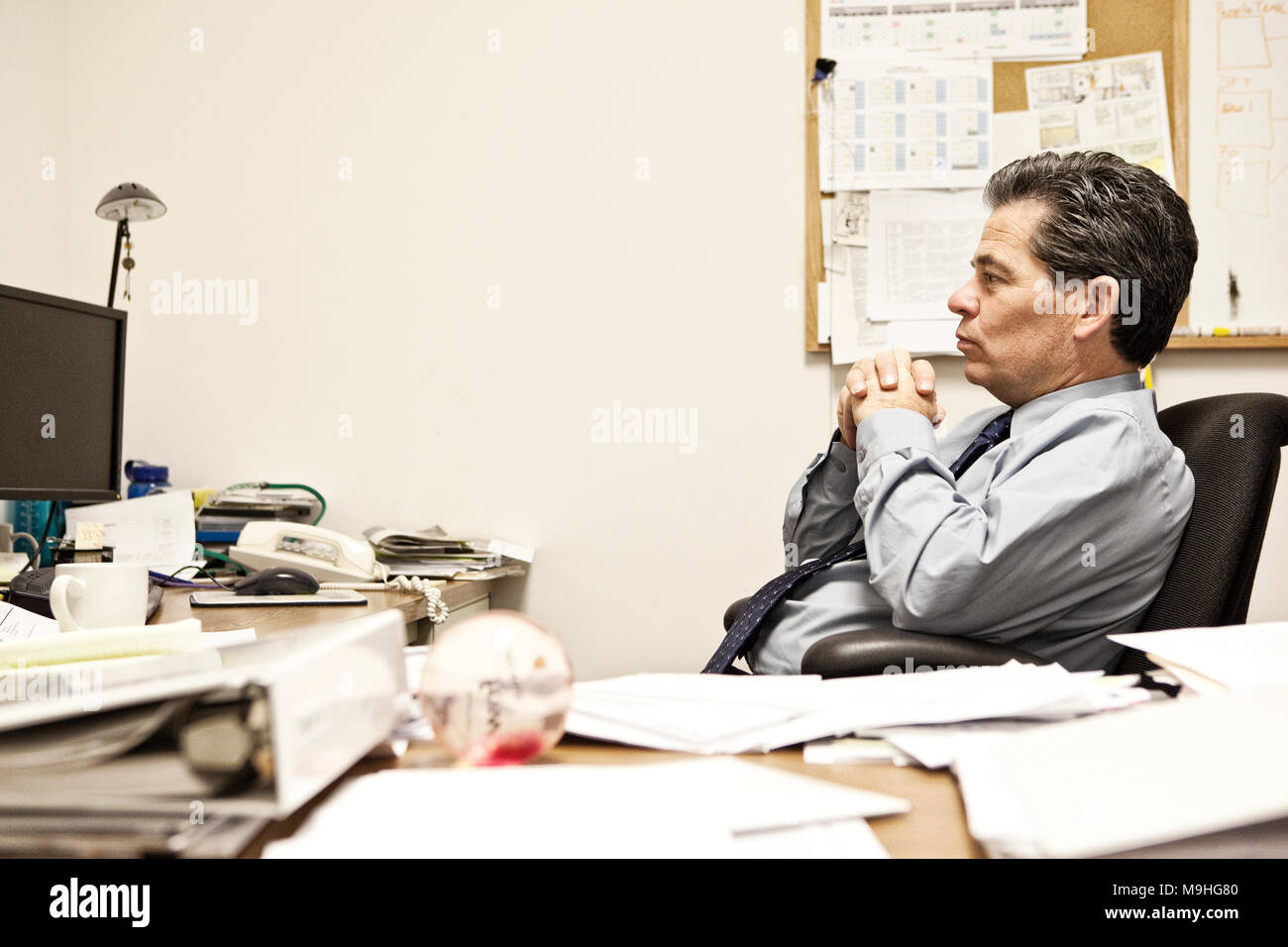 Caucasian man problem solving at his office desk Stock Photo - Alamy