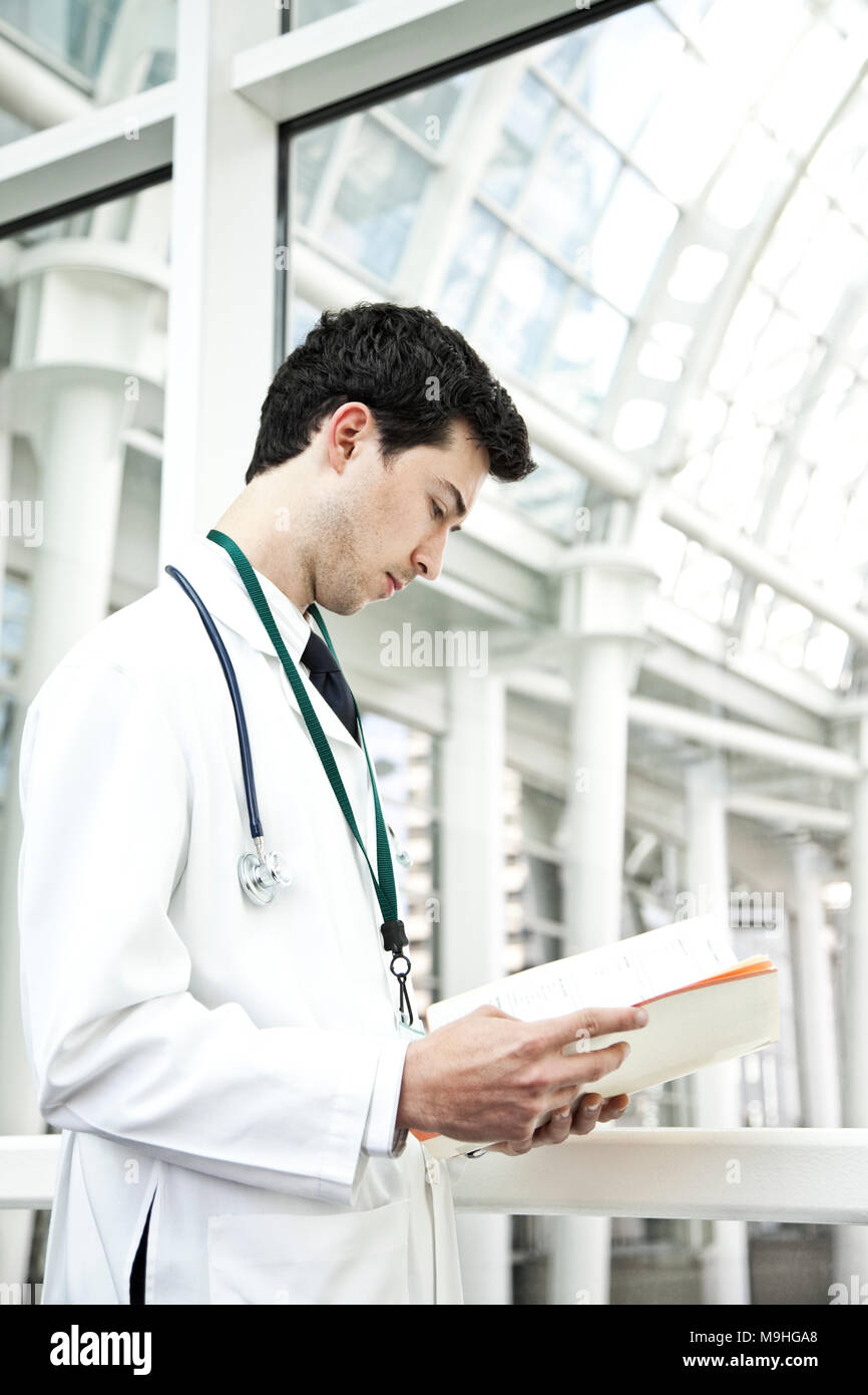 Caucasian man doctor going over a patient history Stock Photo - Alamy