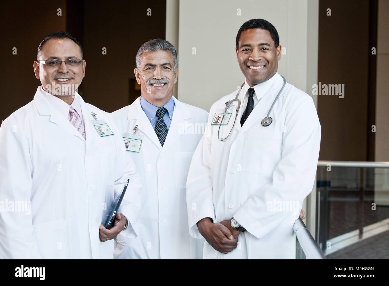 Mixed race group of doctors in lab coats Stock Photo - Alamy