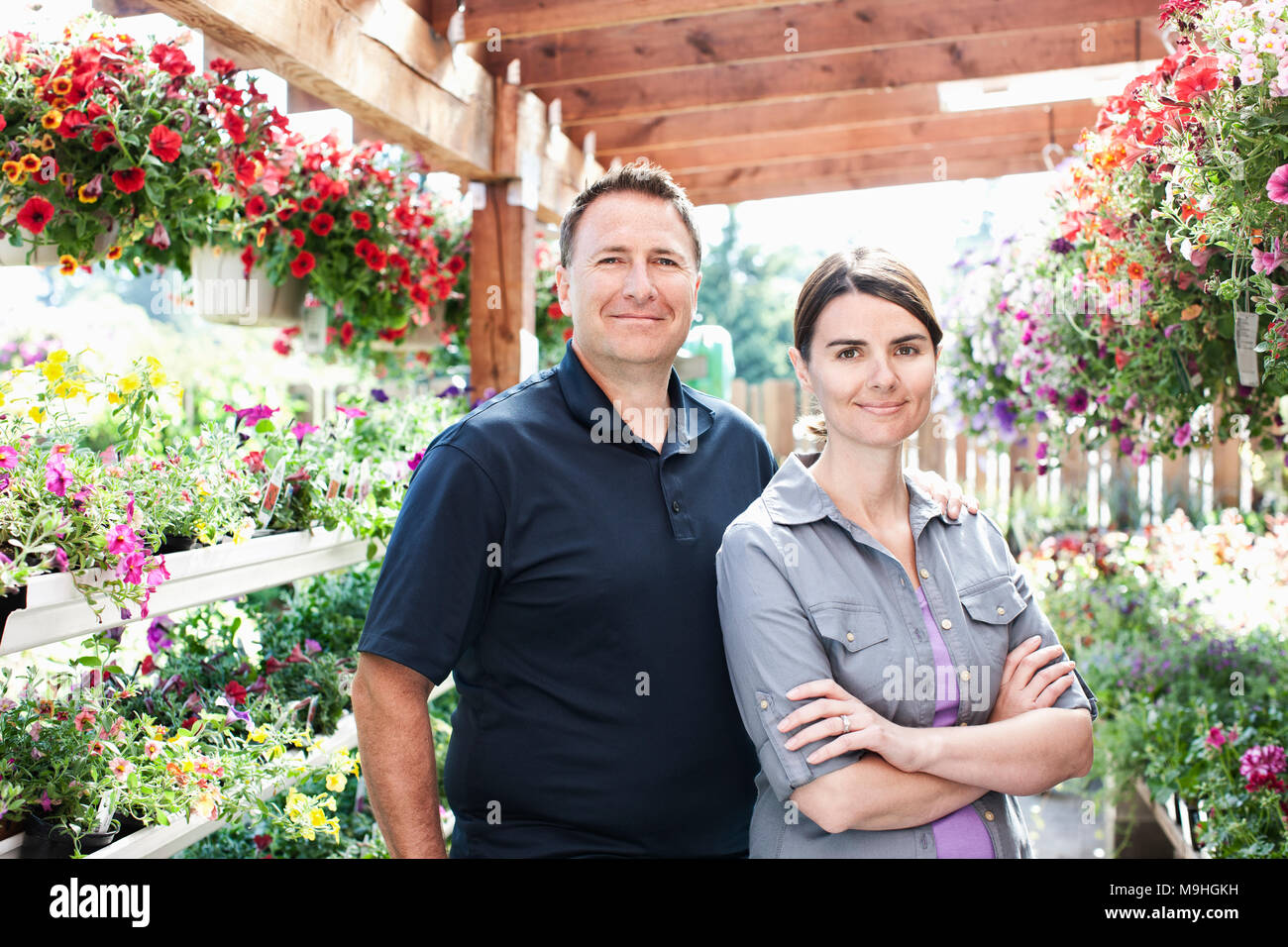 Caucasian man and woman owners of a small plant nursery Stock Photo - Alamy