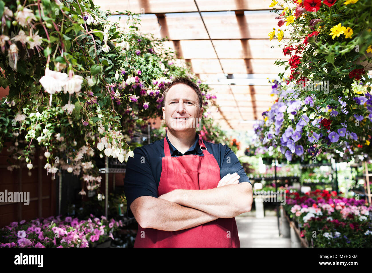 Caucasian man nursery owner standing with plants for sale at the ...